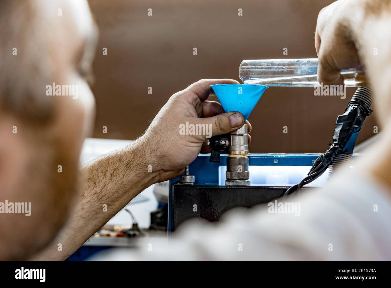 Professional mechanic working on fuel injector cleaning machine in car ...