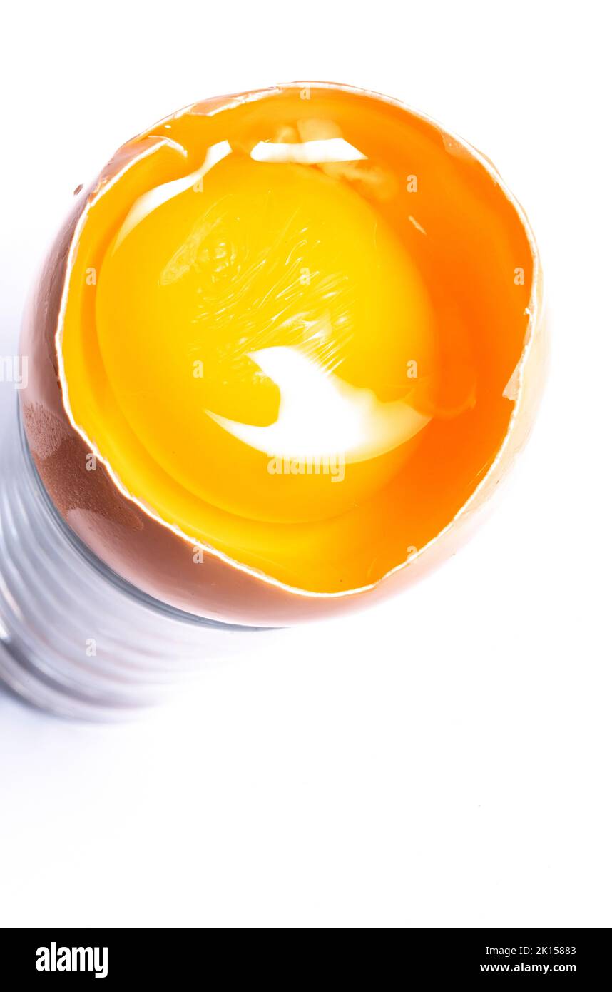 Egg yolk in a shell isolated on a white background. Egg yolk close-up ...