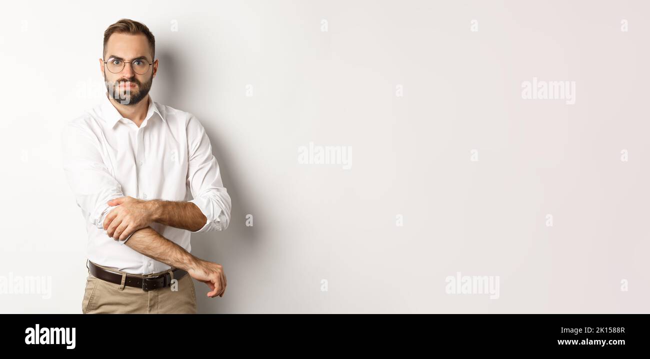 Angry man roll up sleeves and looking offended, getting ready to fight ...