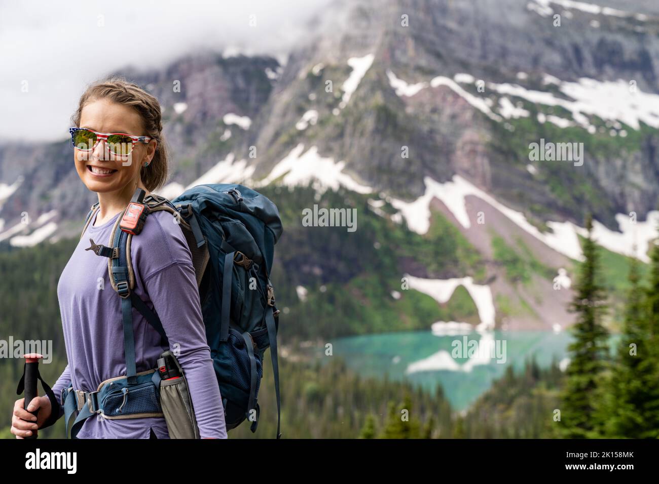 Woman hiker takes a moment to enjoy the scenery along the Grinnell ...