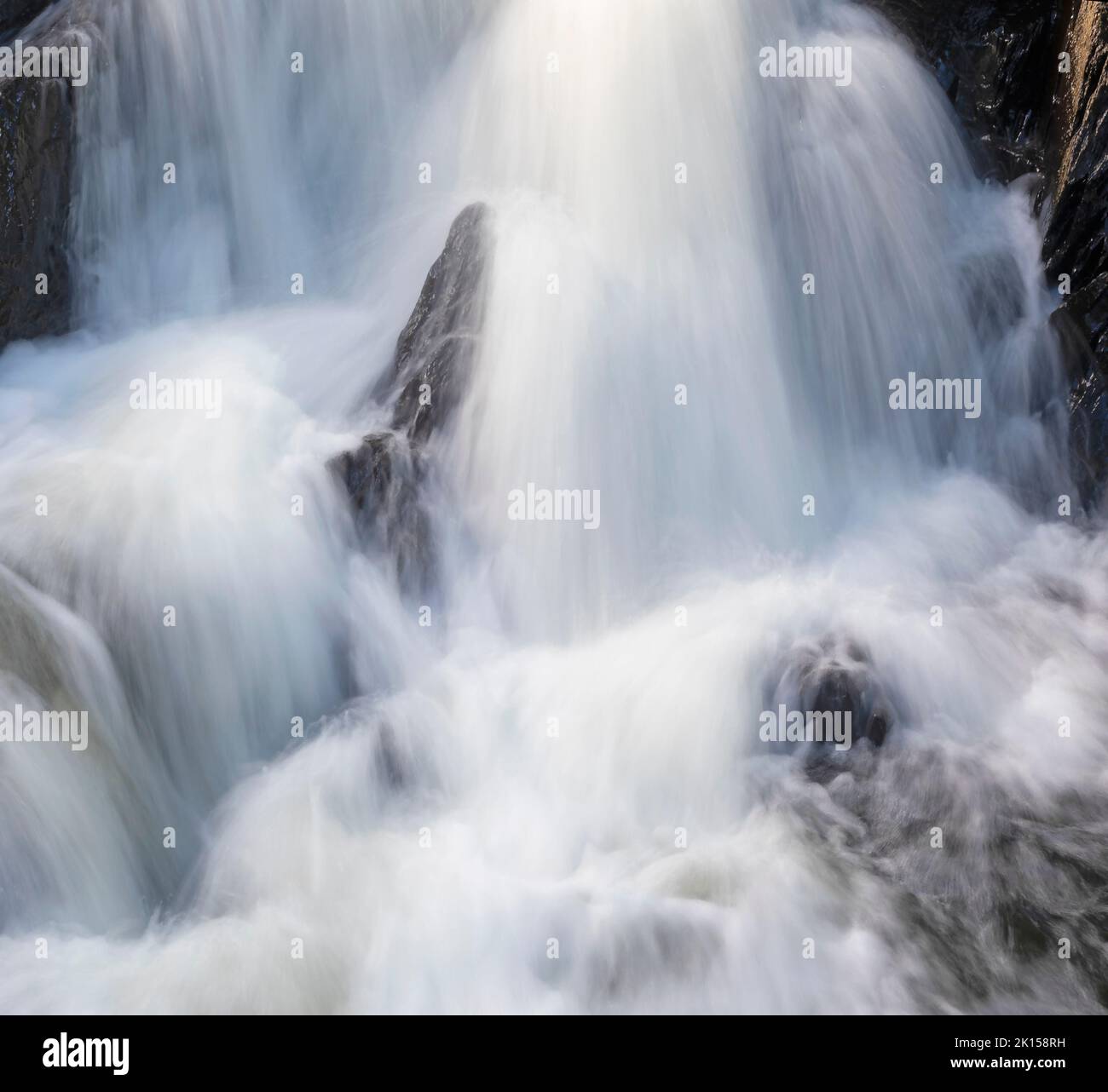 Fast falling waterfall over boulders that is in Maine Stock Photo - Alamy