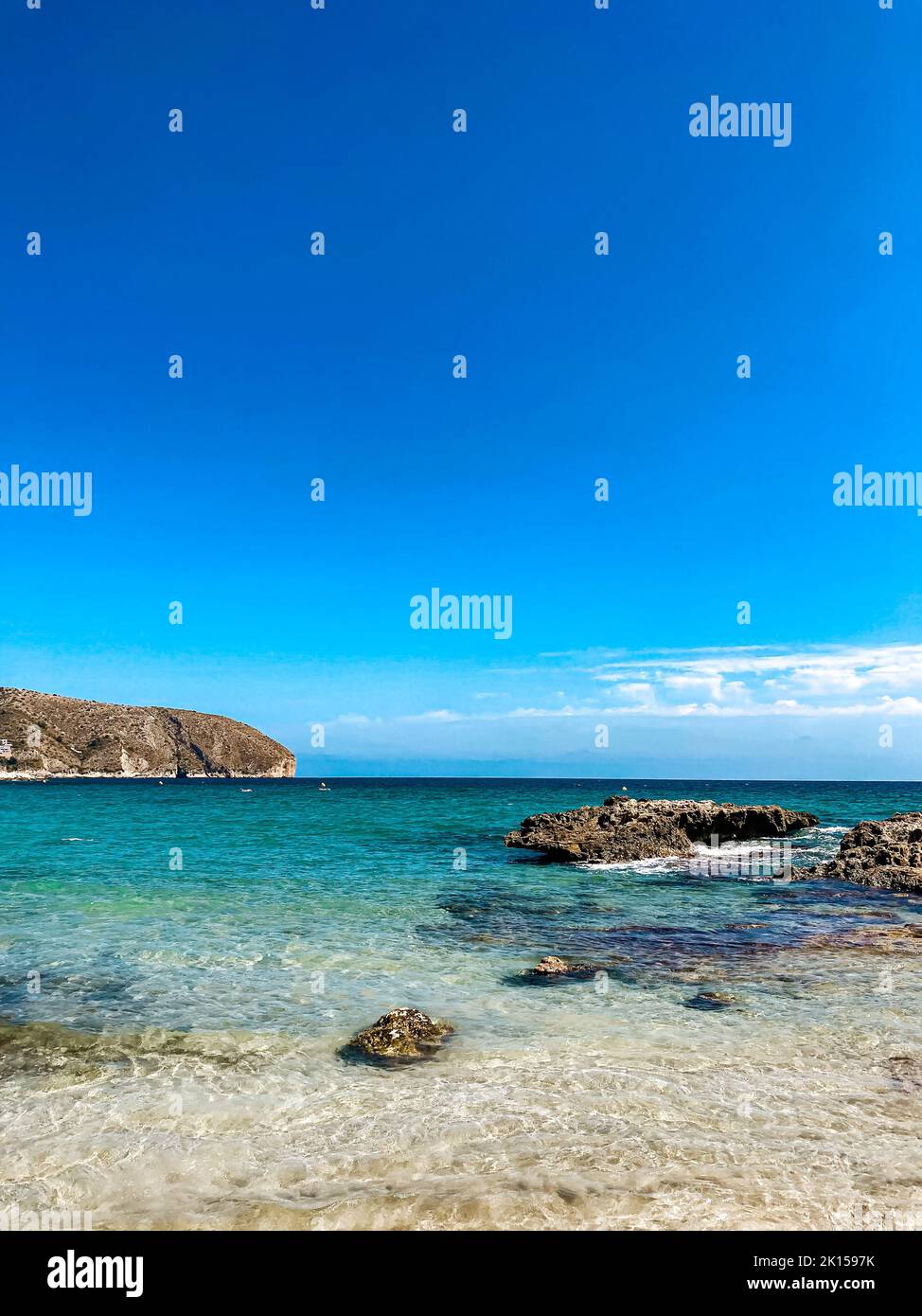 Beautiful scenery of Playa de l'Ampolla beach and sea in Moraira, East ...
