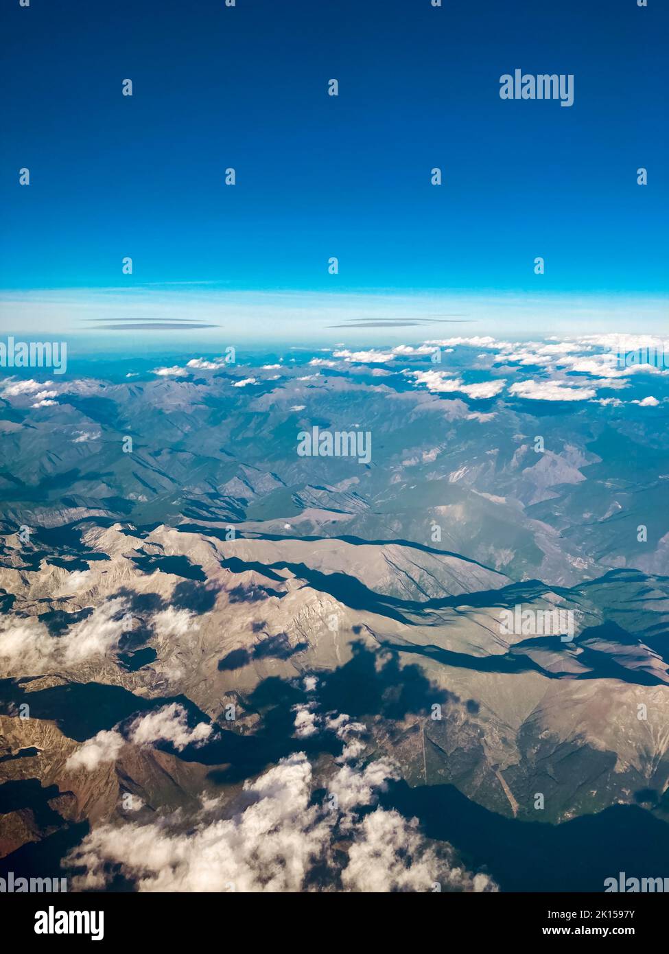 Amazing view from a plane of mountains (mountain range) with clouds ...