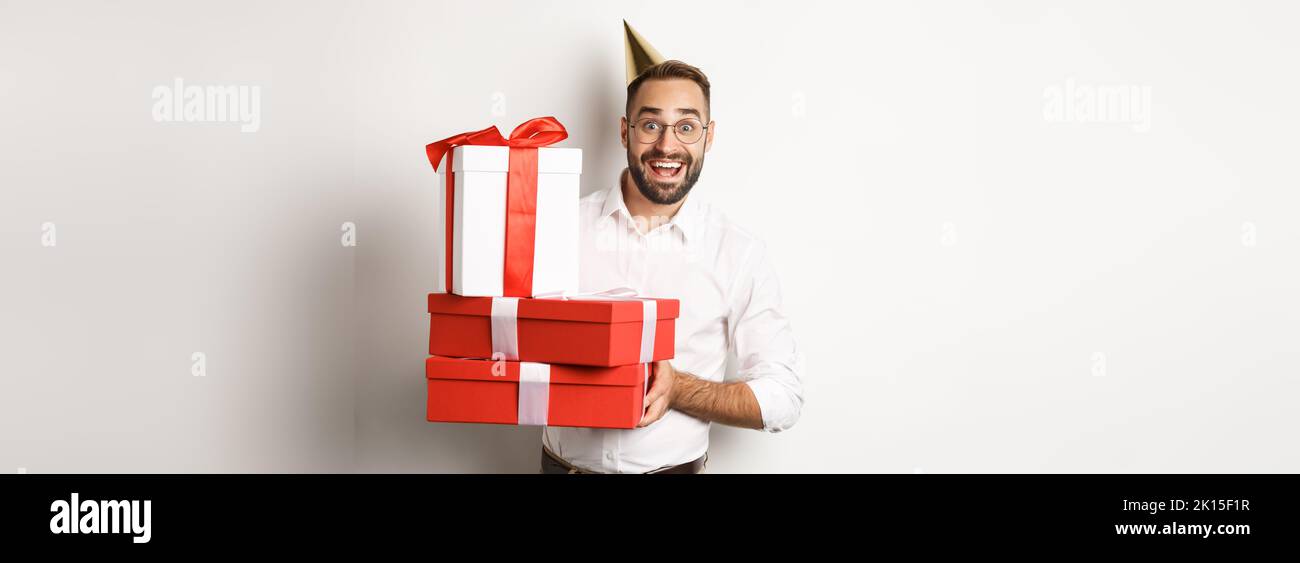 Holidays and celebration. Happy man receiving gifts on birthday ...