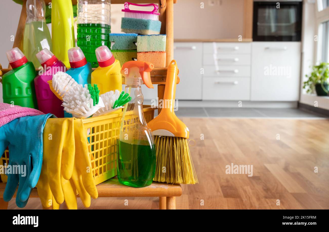 Close up of cleaning products arranged on wooden shelves in front of ...