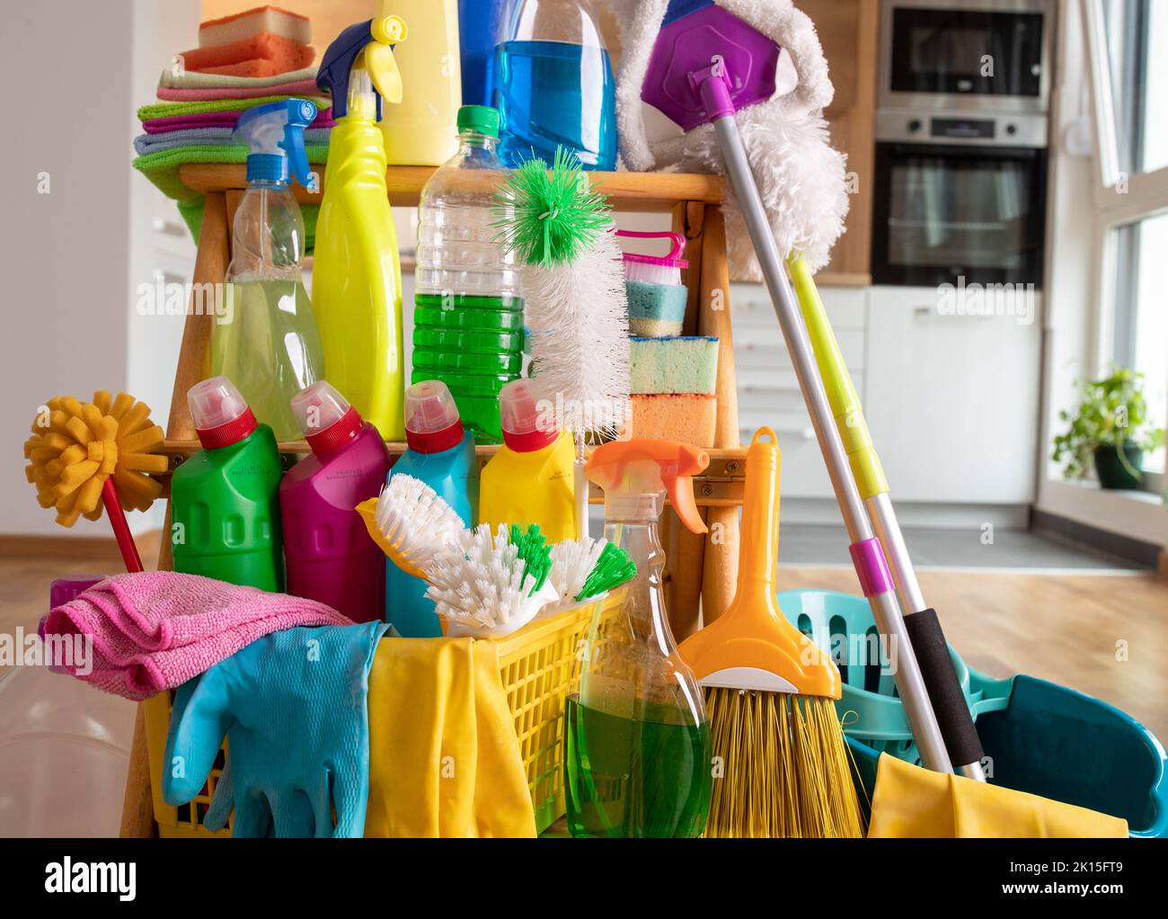 Close up of cleaning products arranged on wooden shelves in front of ...