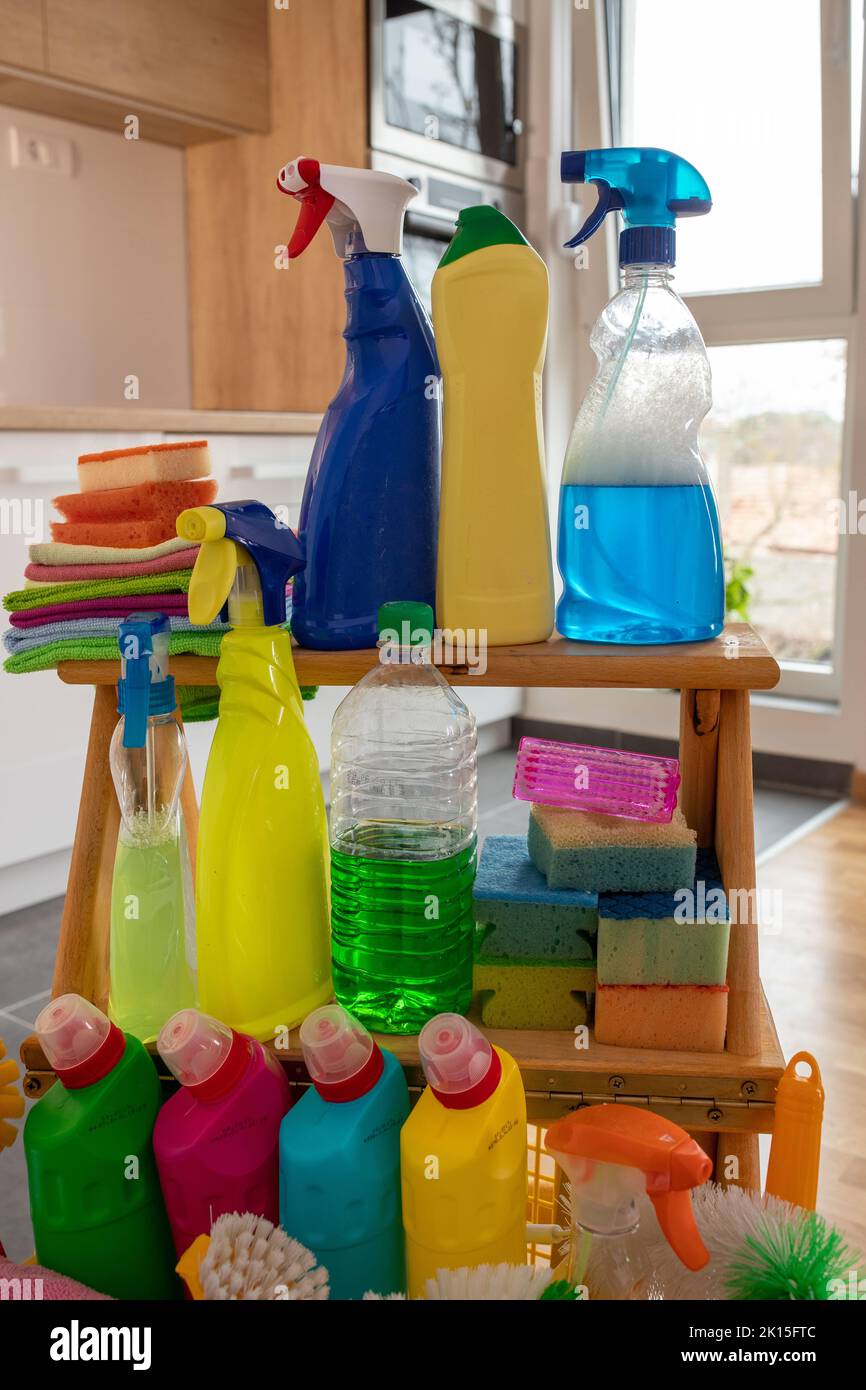 Close up of cleaning products arranged on wooden shelves in front of ...