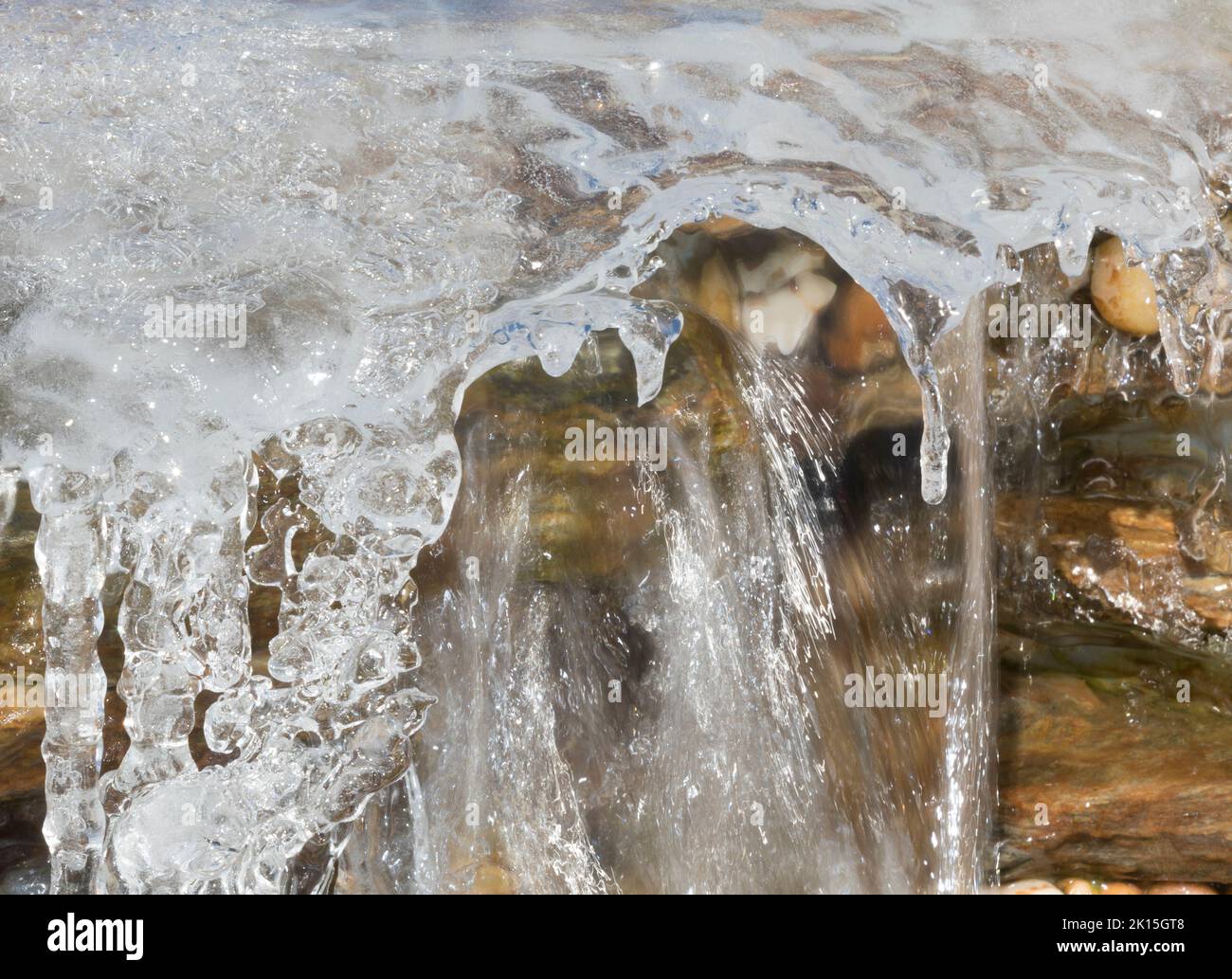Small waterfall covered in ice after the snow bomb cyclone Stock Photo ...