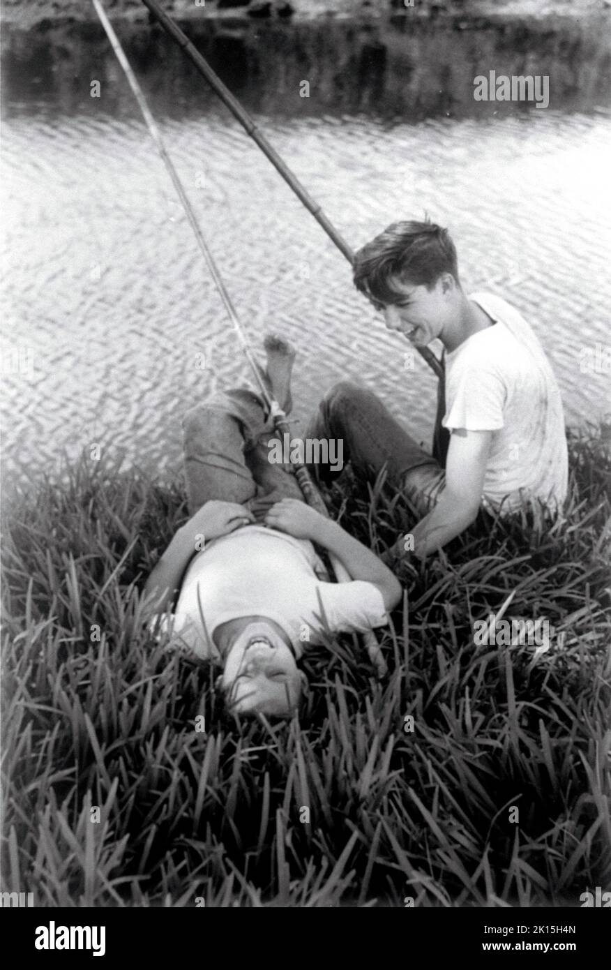 Two boys having fun fishing together. Circa 1957 Stock Photo - Alamy