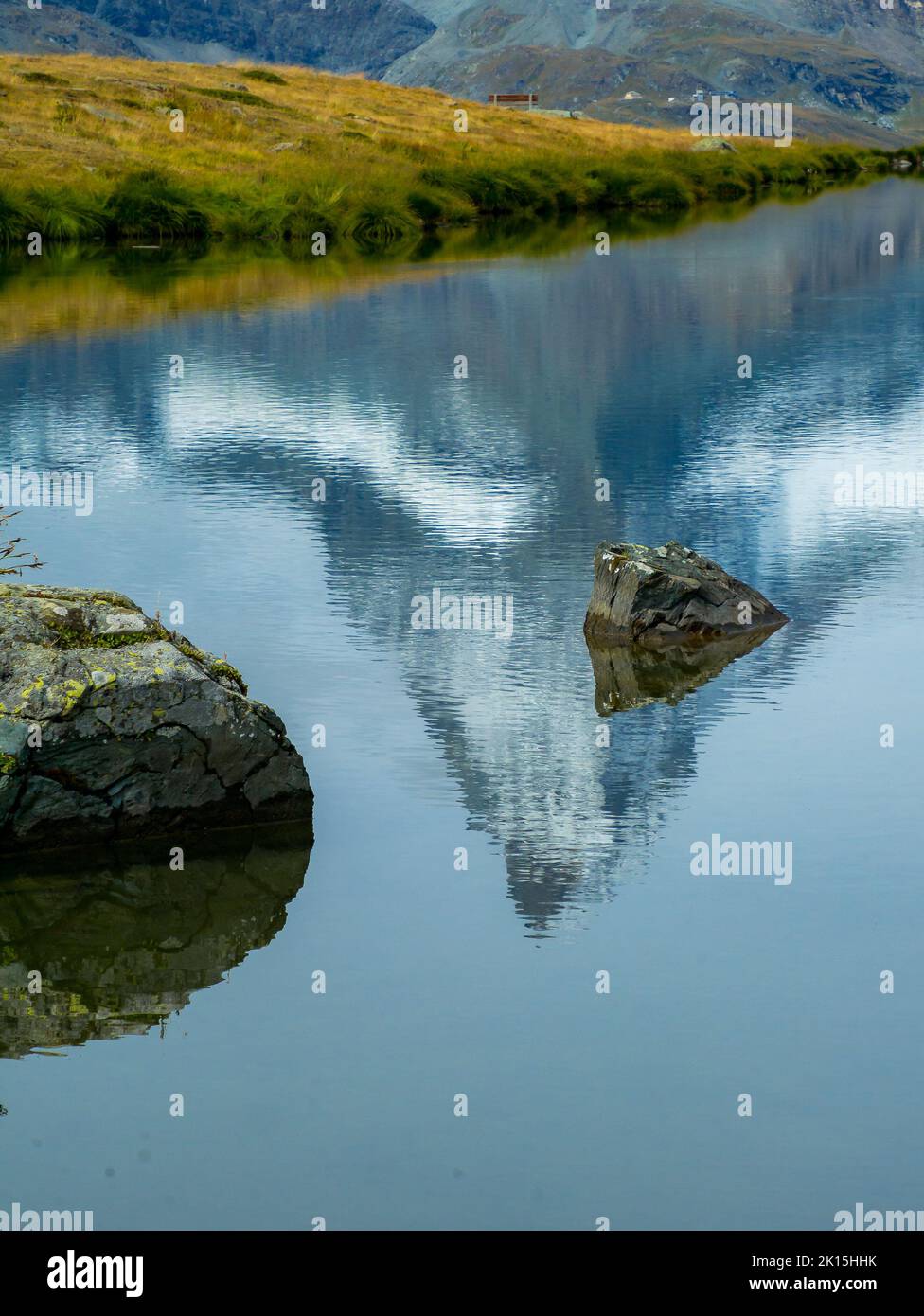 The snowy peak of the Matterhorn in Switzerland is reflected in the ...