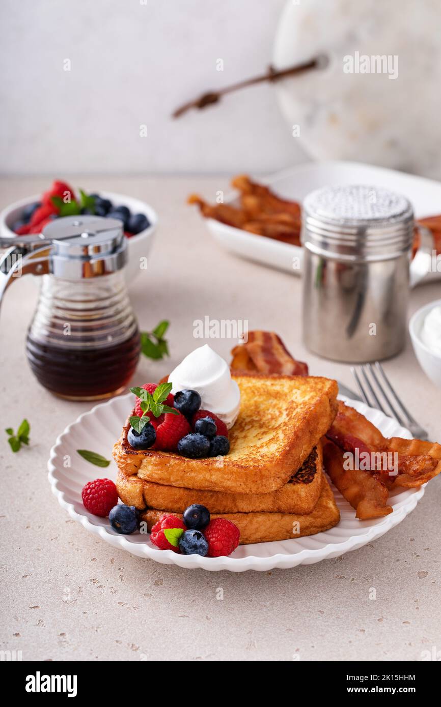 Classic french toast with bacon and berries Stock Photo - Alamy