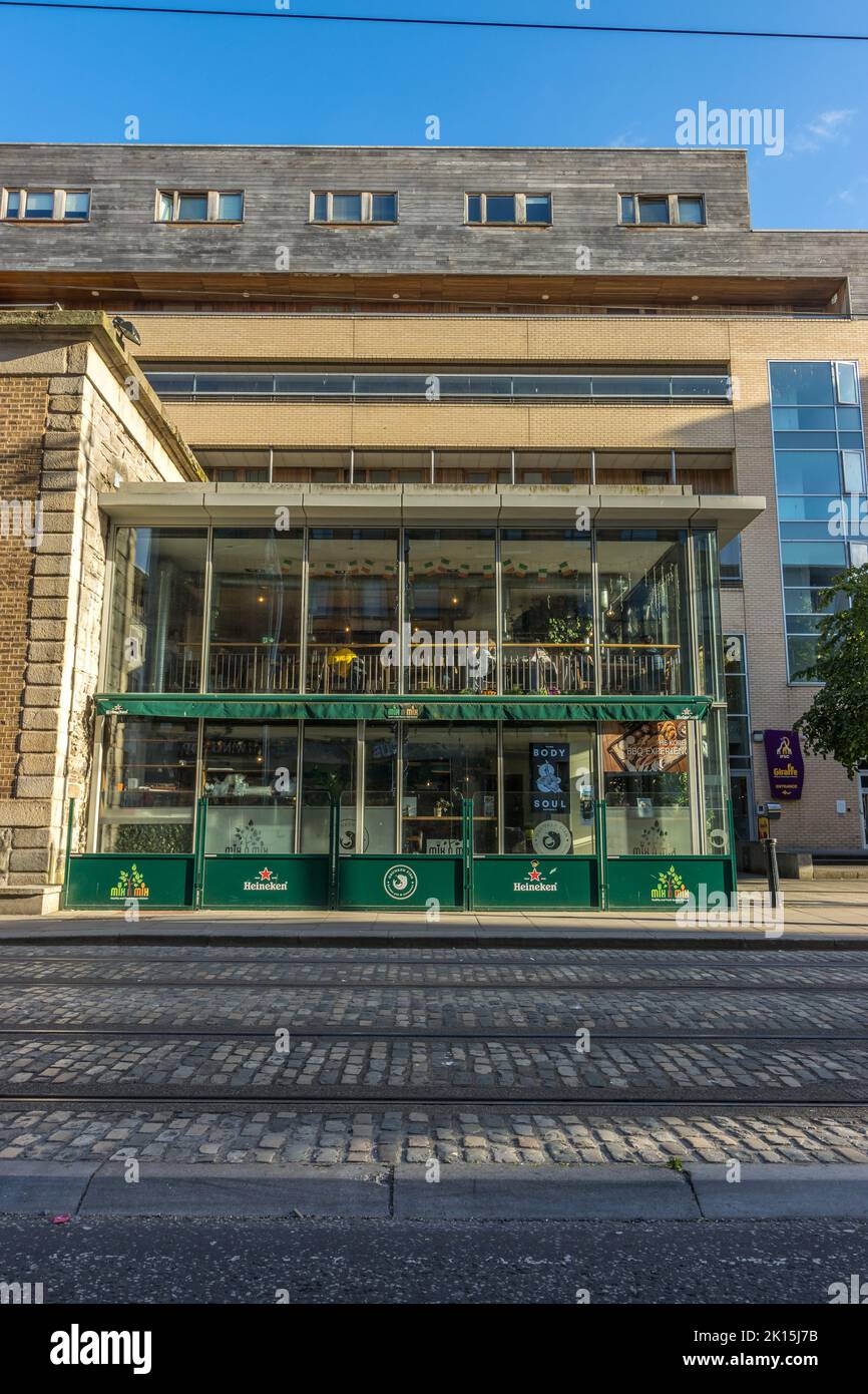 A cozy corner cafe shot and tramway lines in Dublin Docklands, Ireland ...