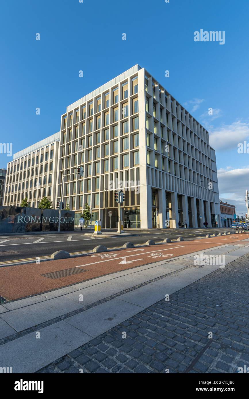 A vertical shot of modern buildings in Dublin Docklands and the signage ...
