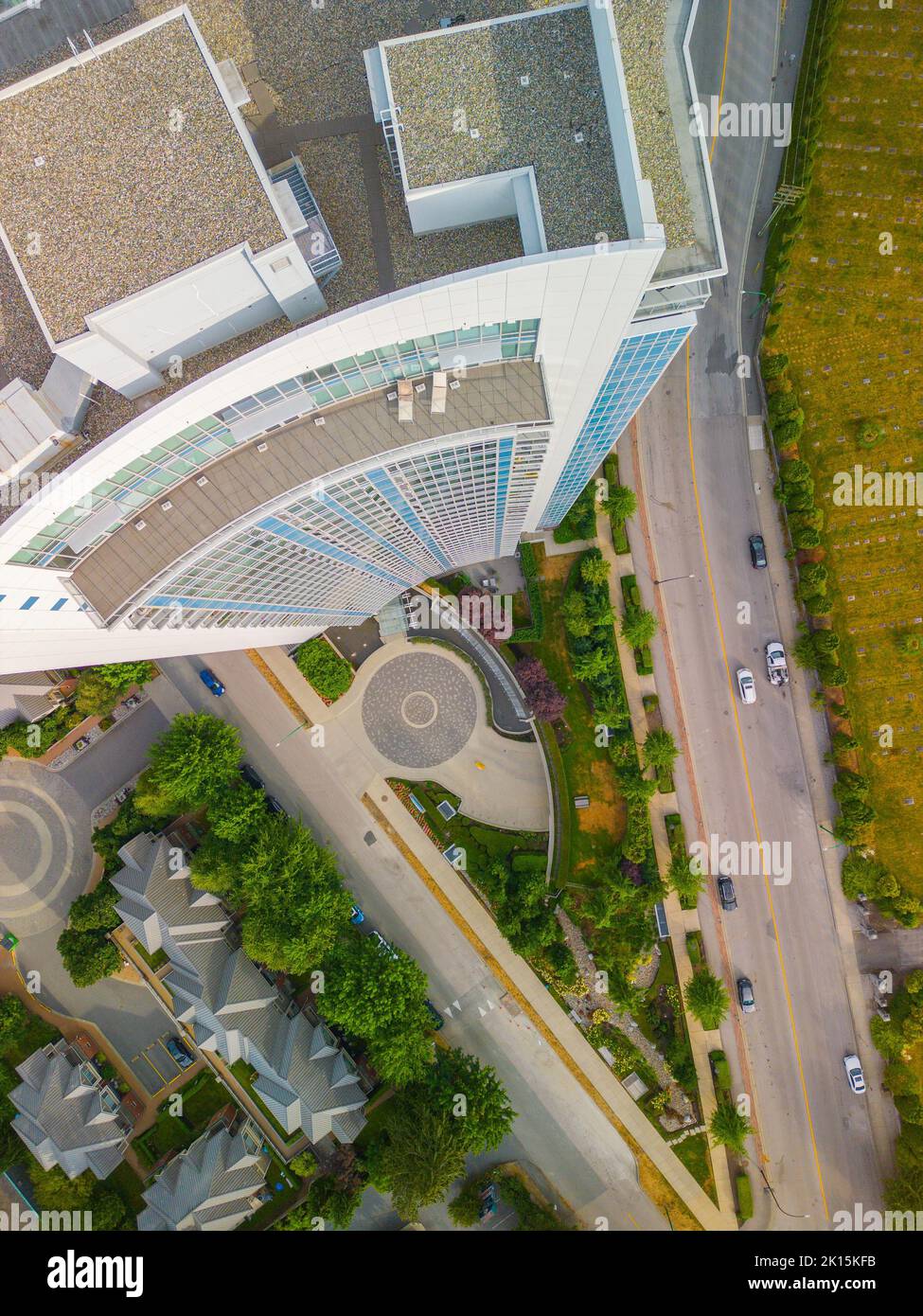 A top view of a beautiful modern skyscraper with a garden and traffic ...