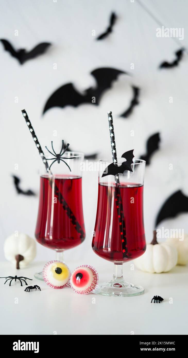Close-up of two bloody cocktails glass goblets for Halloween,bottle ...