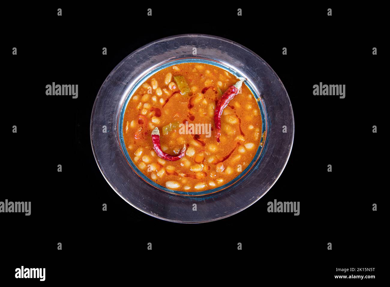 Haricot bean. Dried beans,white beans in tomato sauce in a copper bowl ...