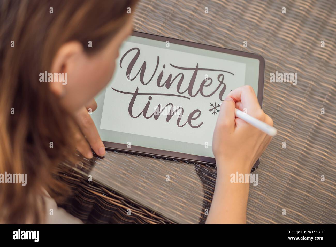 Calligrapher Young Woman writes phrase on digital tablet. Inscribing ...