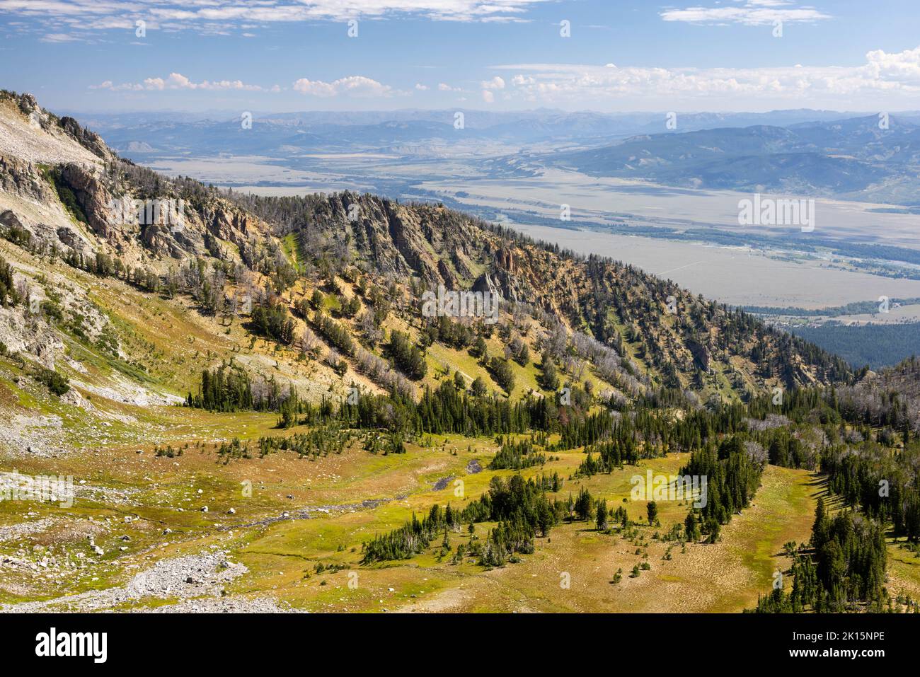 The Teton Mountains descending toward the valley of Jackson Hole below ...