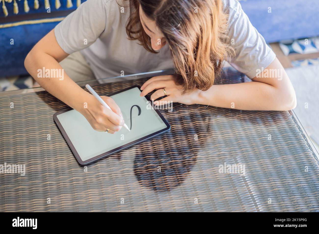 Calligrapher Young Woman writes phrase on digital tablet. Inscribing ...