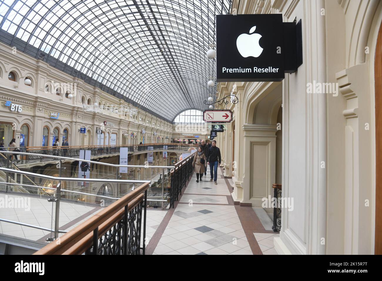 People walk on the background of premium reseller apple signage Stock ...