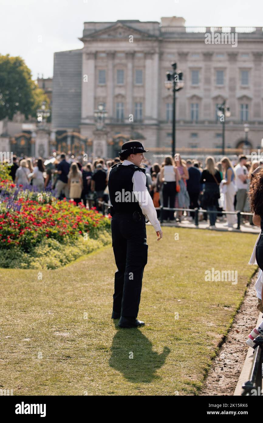 Police officer standing outside Buckingham Palace, protecting the ...
