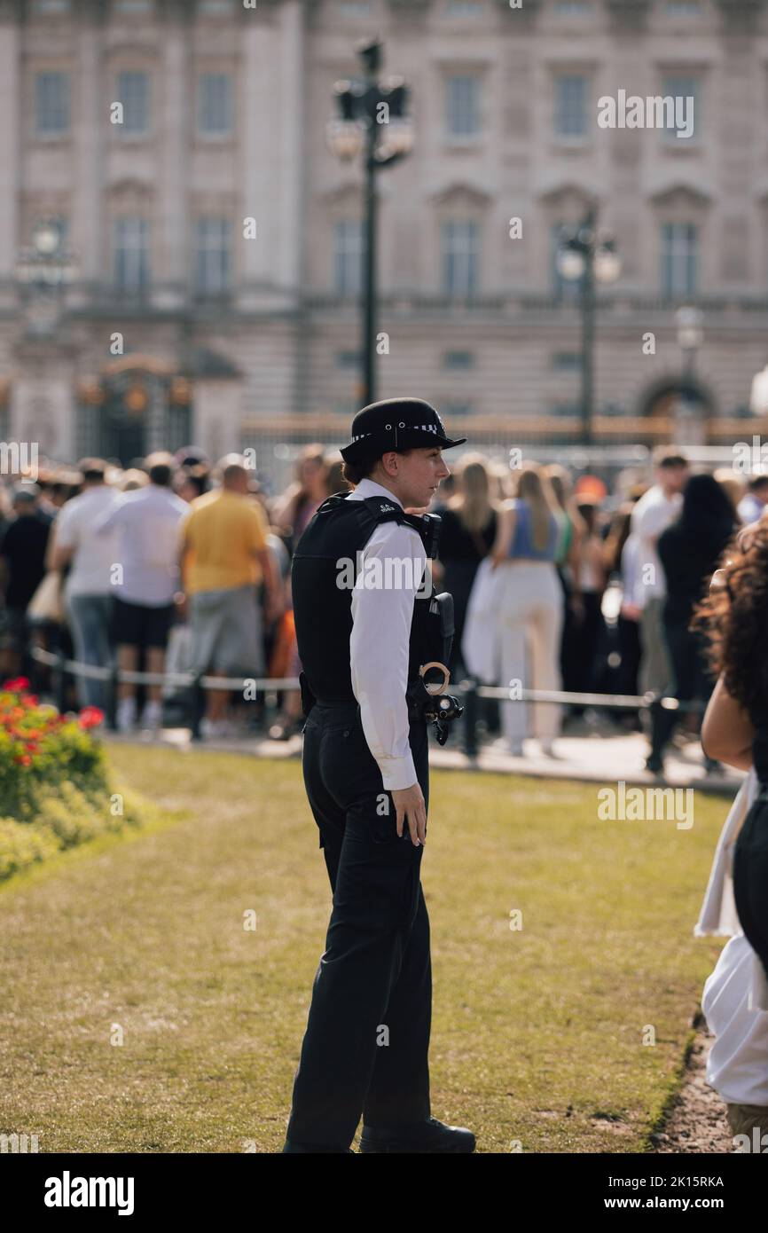 Police officer standing outside Buckingham Palace, protecting the ...