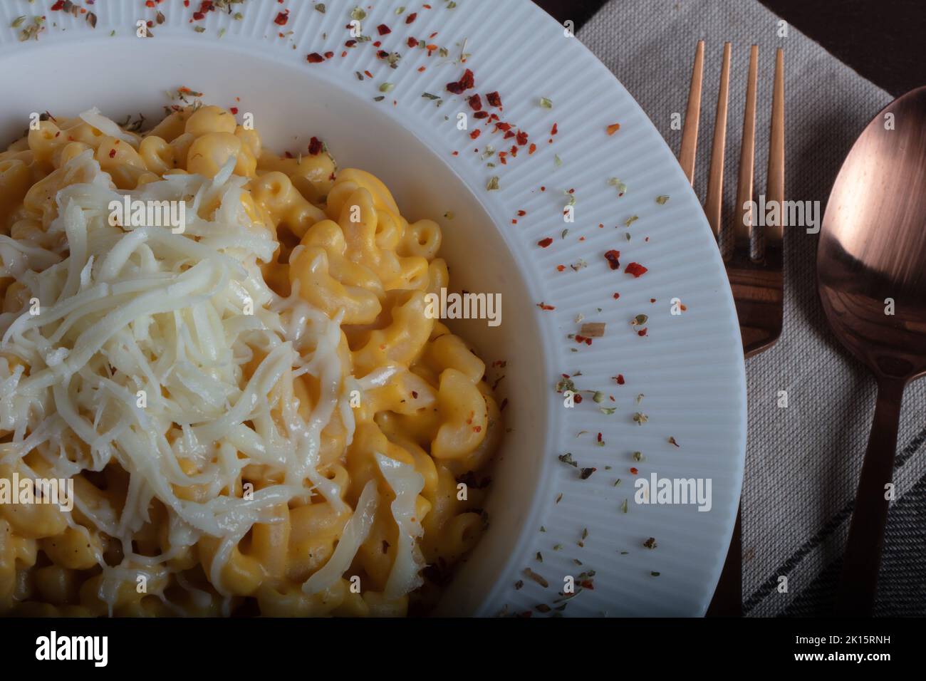 Mac and cheese, american style macaroni pasta with cheesy sauce on dark ...