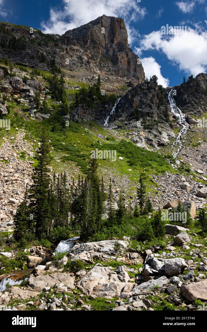 Teton peaks in the South Fork of Cascade Canyon rising high above large waterfalls pouring down ...
