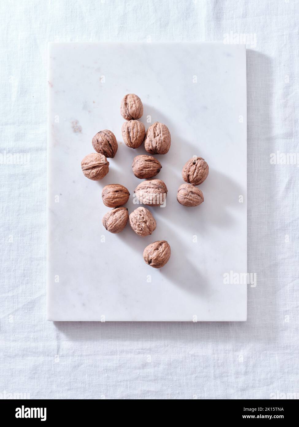 Opening walnuts with a cracker top view. White background Stock Photo ...