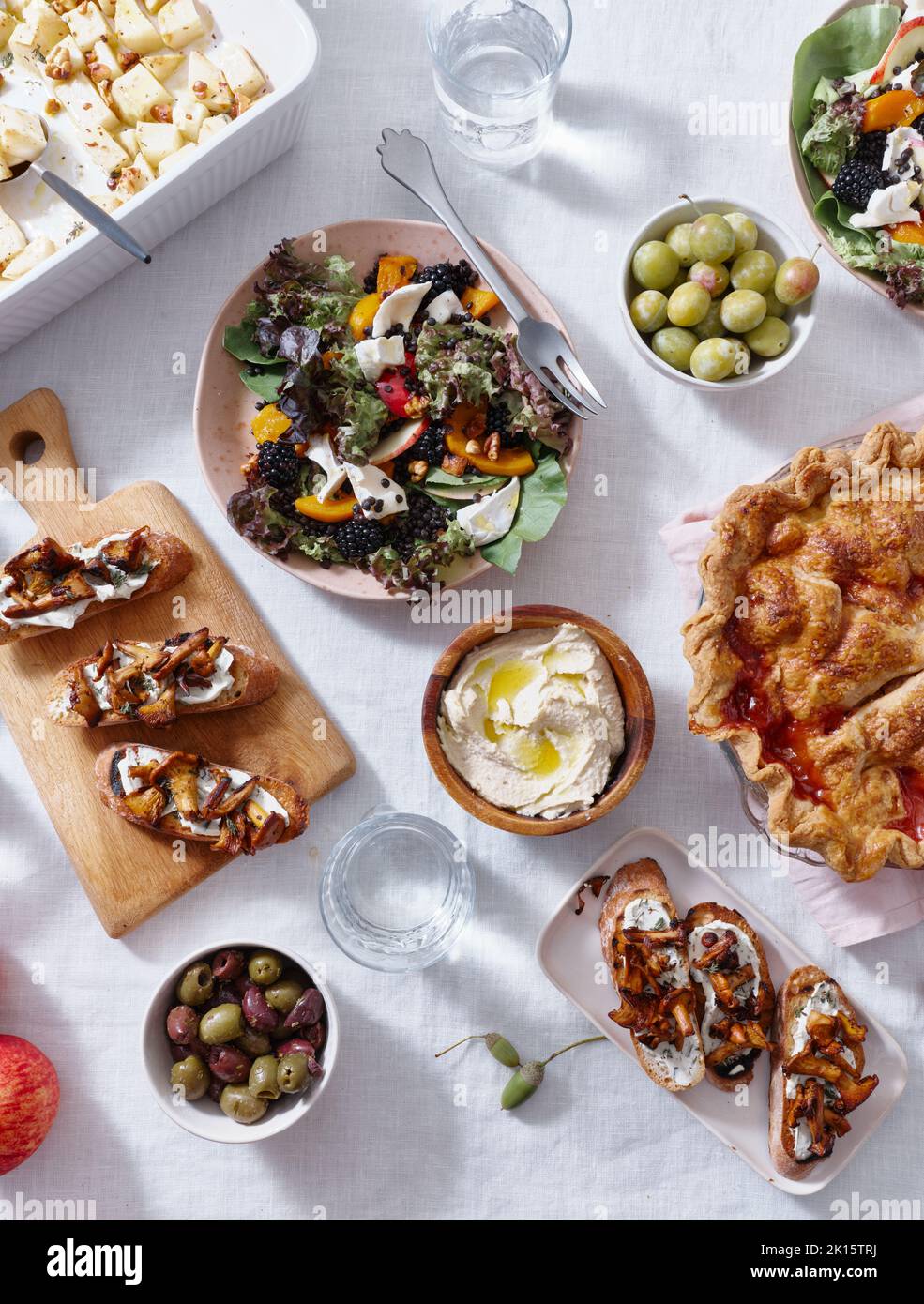 Vegetarian dinner with various snacks and dishes: salad plates ...