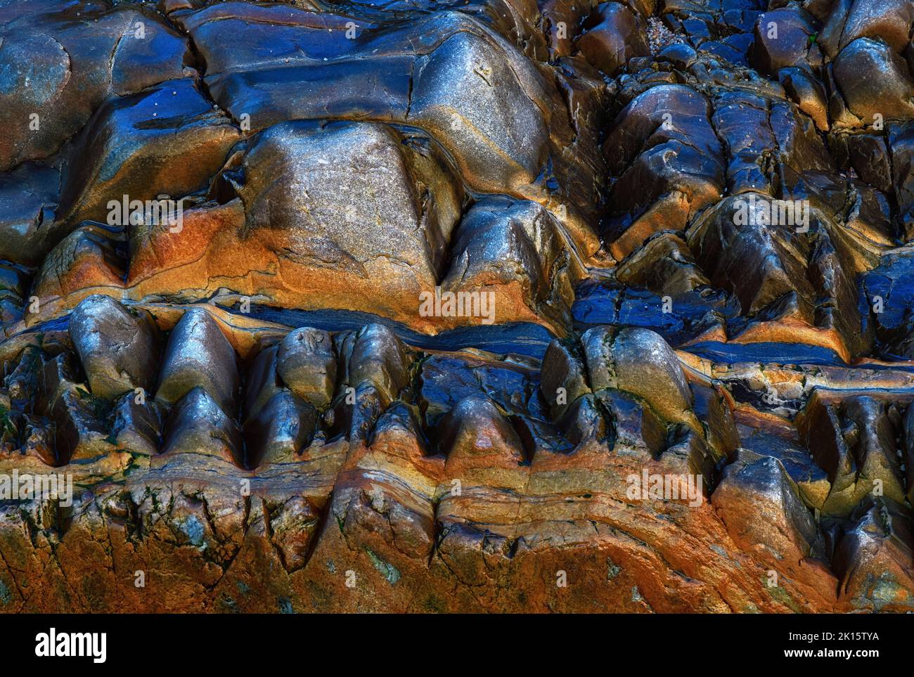 Textured background of smooth blue and brown metamorphic stone with ...