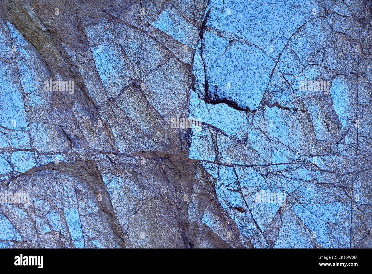 Textured background of natural granite rock cliff covered with uneven ...