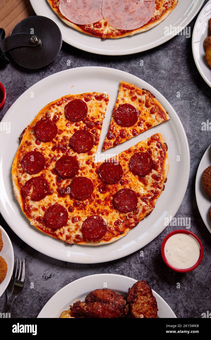 Top view of plate with delicious pepperoni pizza and bowl of sauce ...
