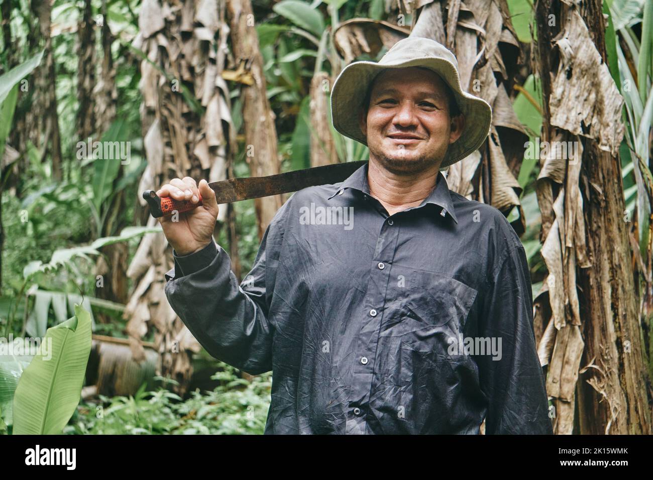 Positive Hispanic man in shirt and bucket hat touching shoulder with ...