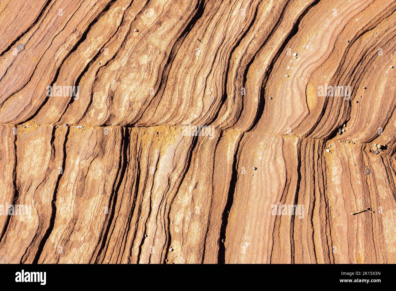 Rough textured surface of sandstone cliff with cracks and uneven lines ...