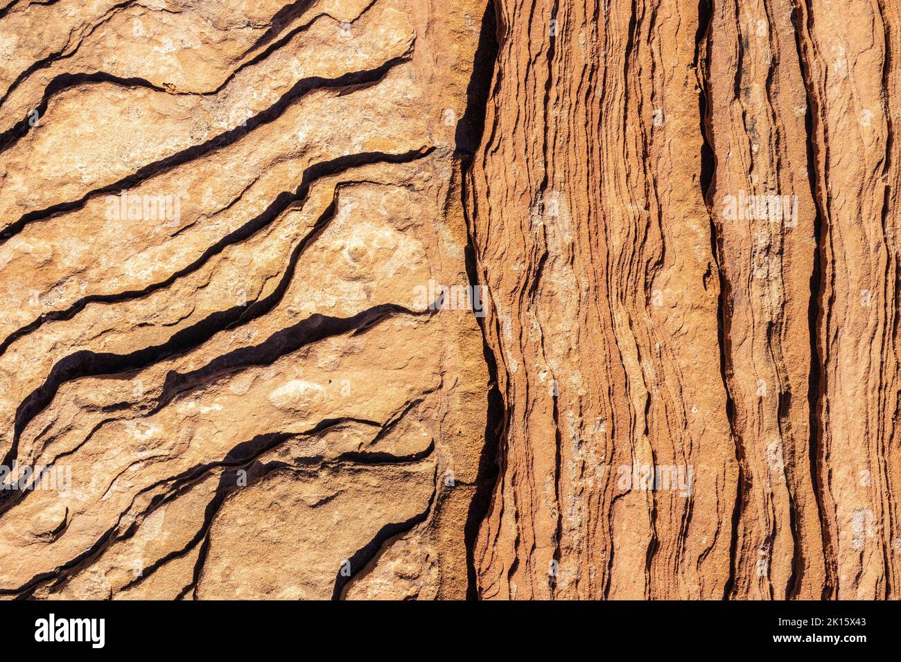 Rough textured surface of sandstone cliff with cracks and uneven lines ...