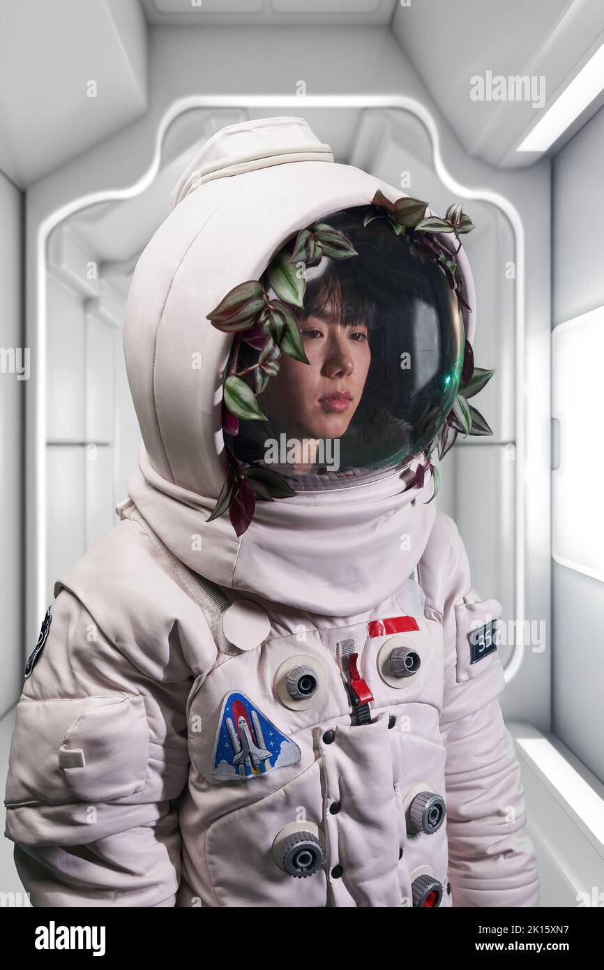 Asian woman in astronaut costume and helmet with green vine looking ...