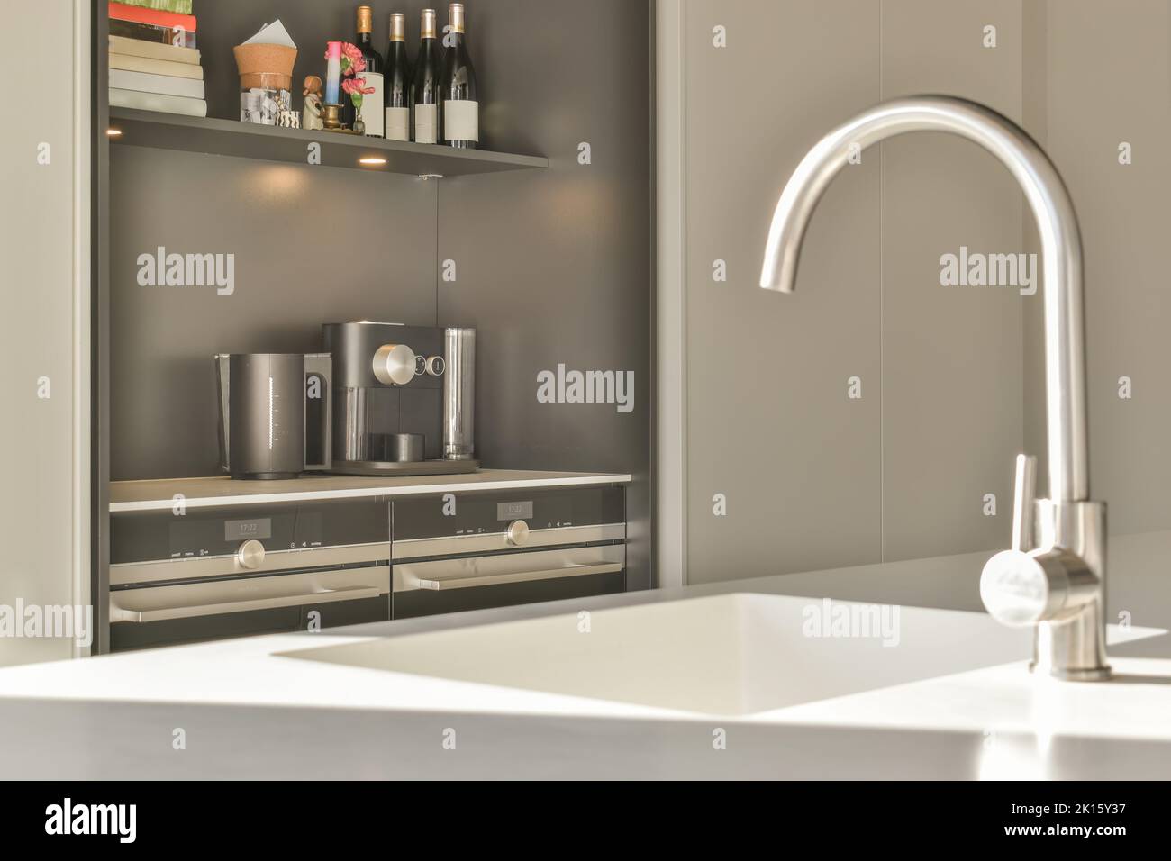Side view of a silver faucet in a modern kitchen in sunlight Stock ...