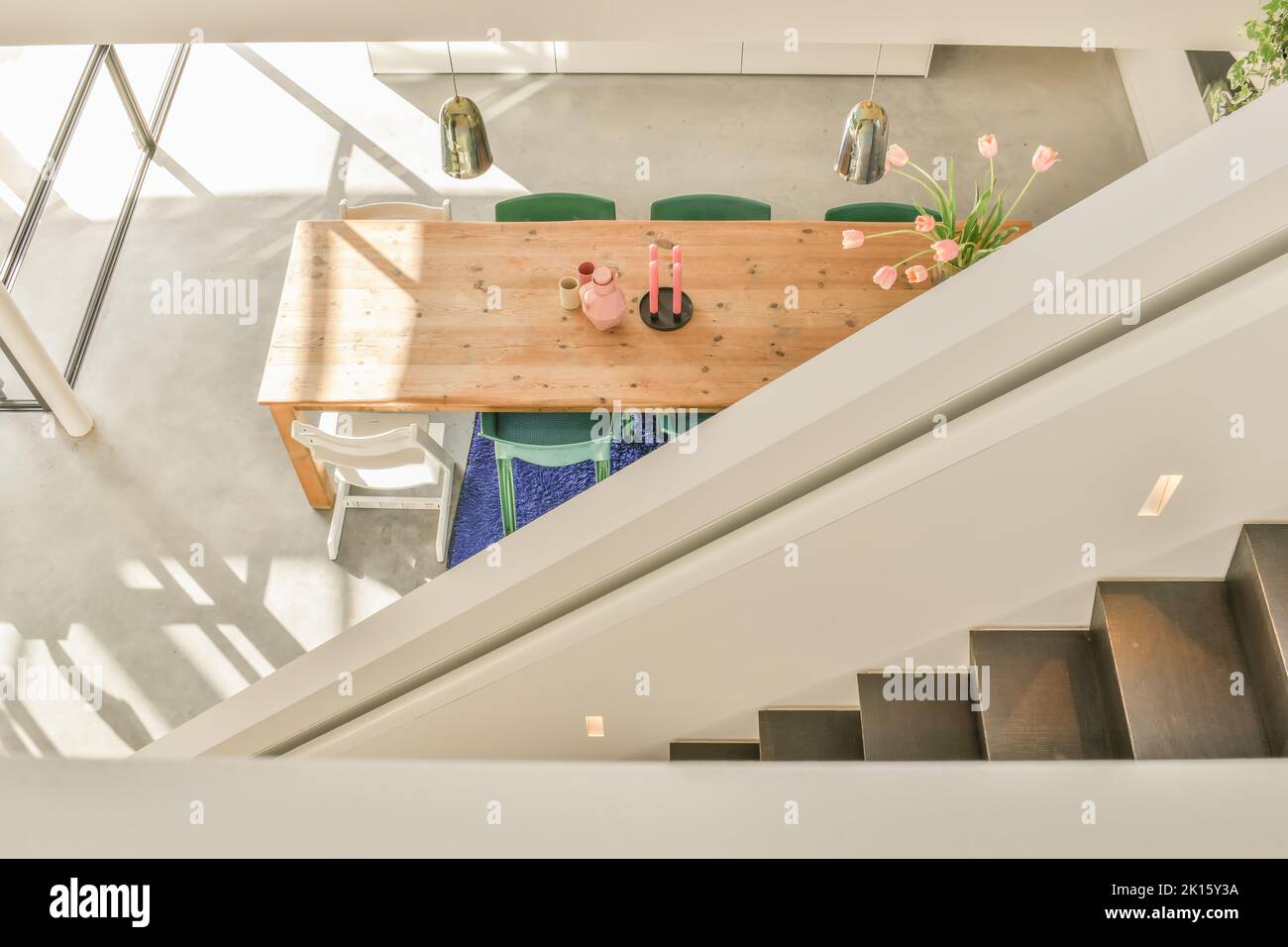 From above interior of modern home with furniture next to a bright ...