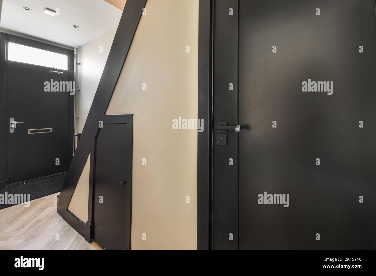 Interior passage way with doors on wall in modern house Stock Photo - Alamy