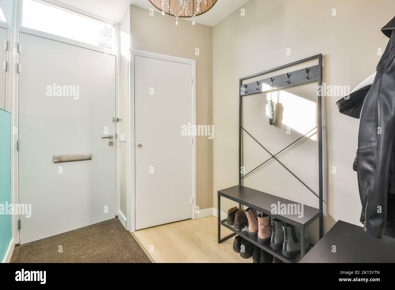 Interior passage way with coat rack on wall in modern house Stock Photo ...