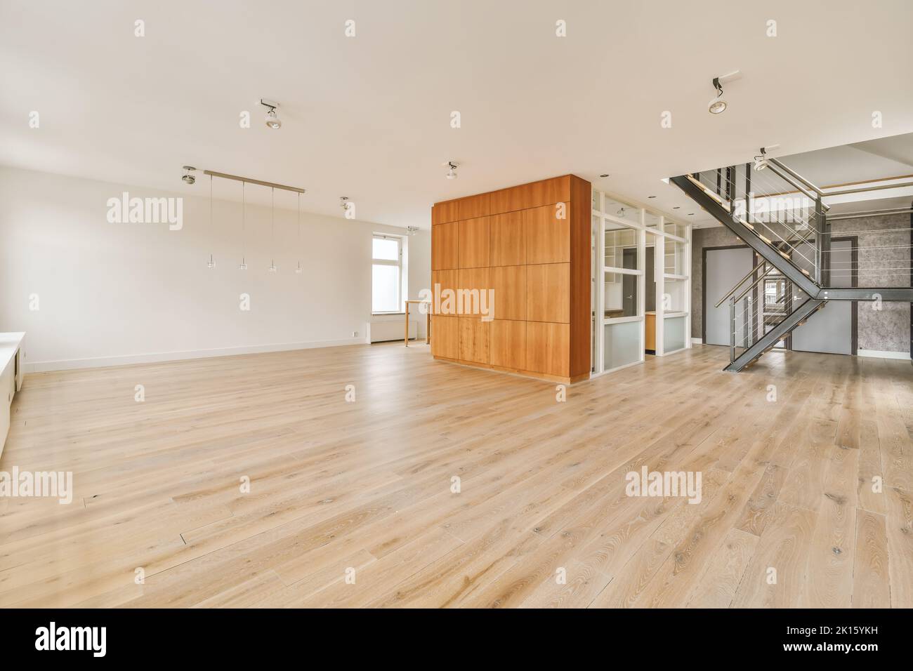 Interior of spacious empty light room with windows, white walls and ...