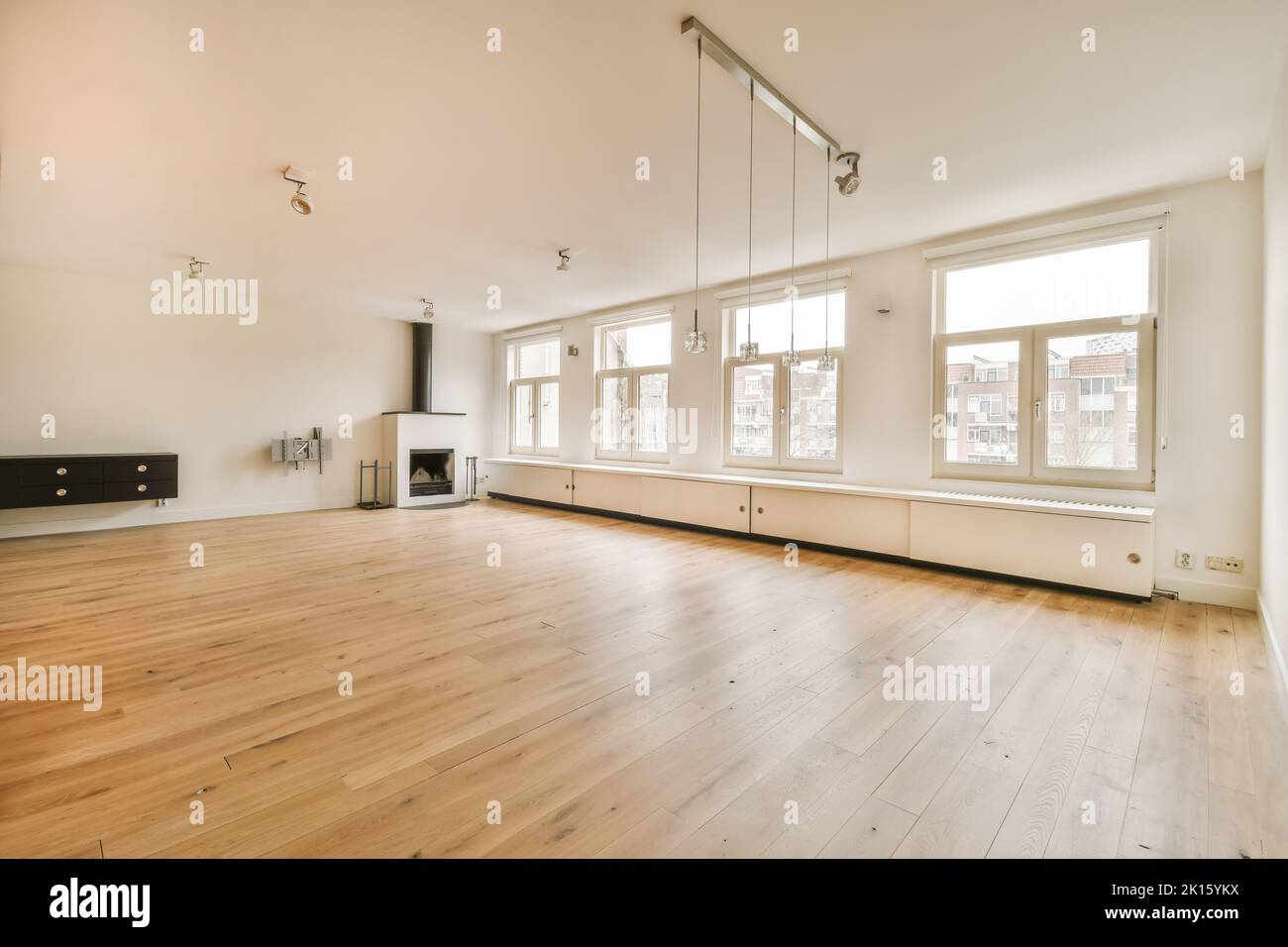 Interior of spacious empty light room with windows, white walls and ...