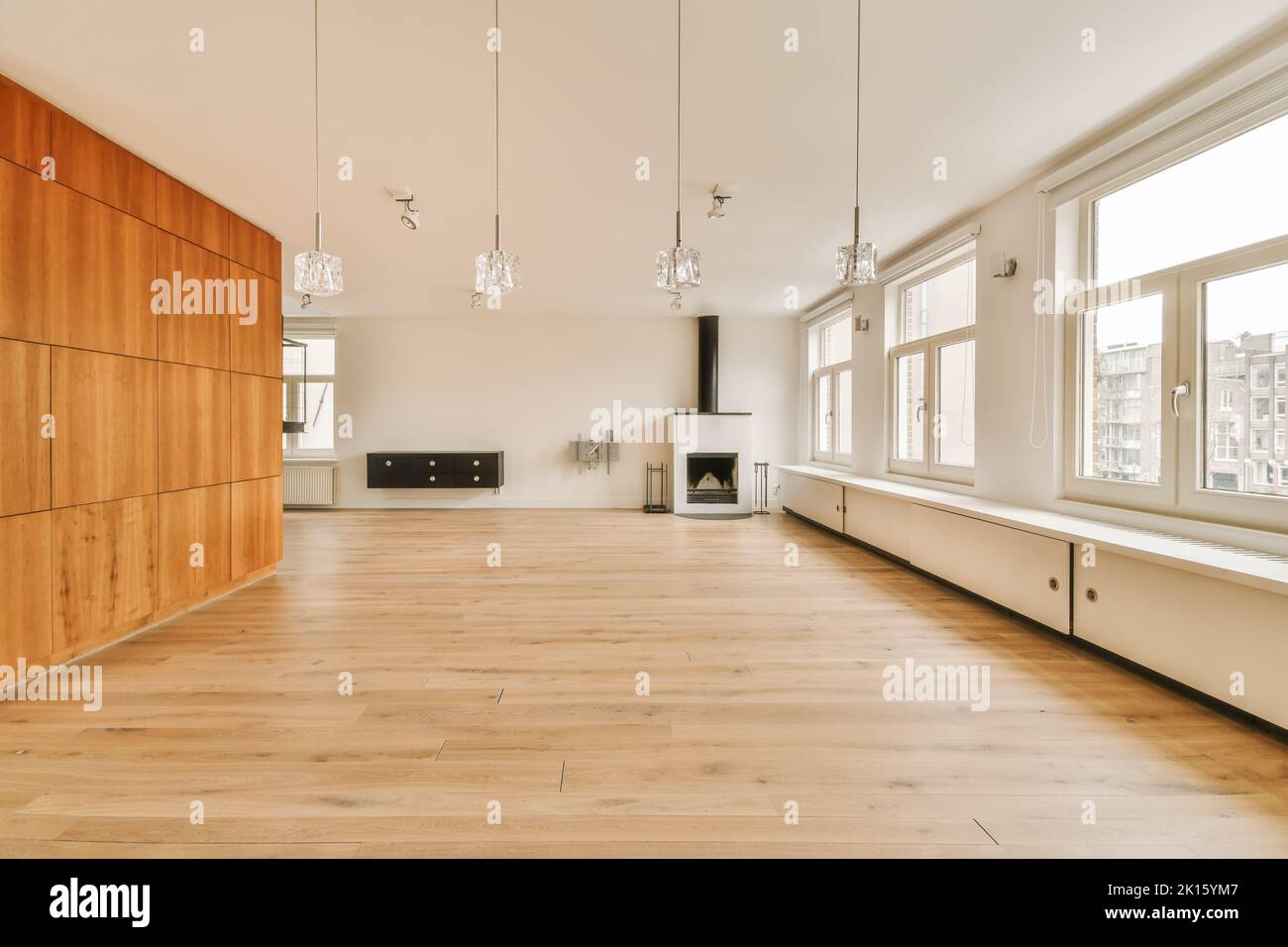 Interior of spacious empty light room with windows, white walls and ...