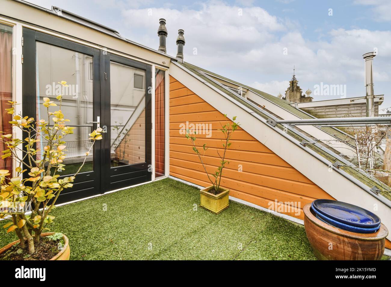 Terrace of typical residential building with tiled roof and windows ...