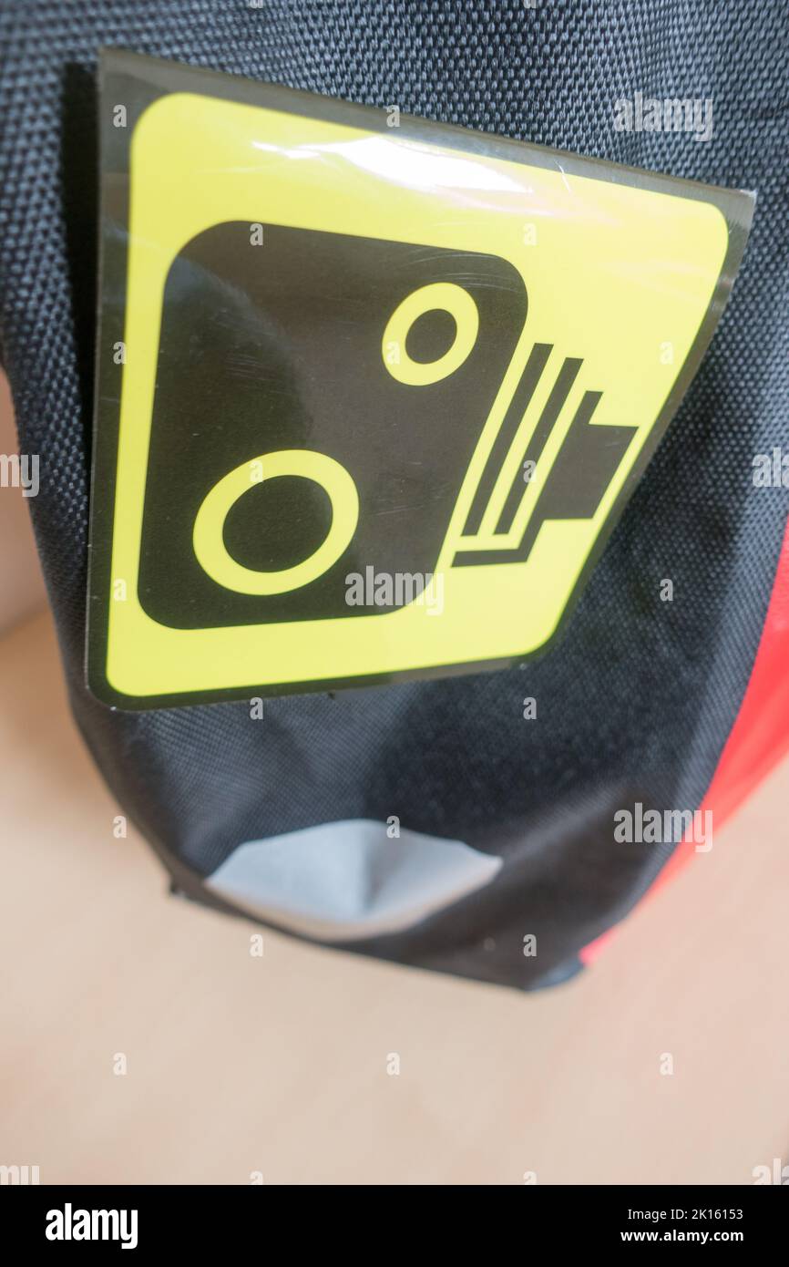 Camera hi-vis symbol on a cycling pannier bag Stock Photo - Alamy