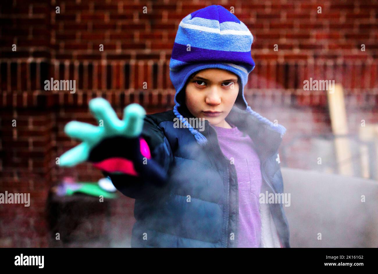 Serious boy standing in smoke pretends to cast spell Stock Photo - Alamy