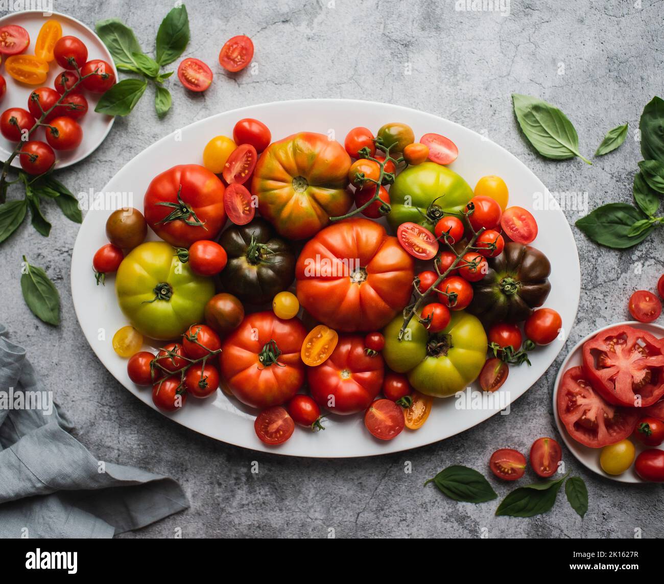 Top view of platter of colorful heirloom and cherry tomatoes Stock Photo - Alamy