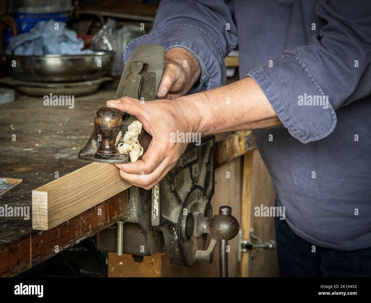a carpenter, or joiner, planing wood on a vice in his workshop Stock ...