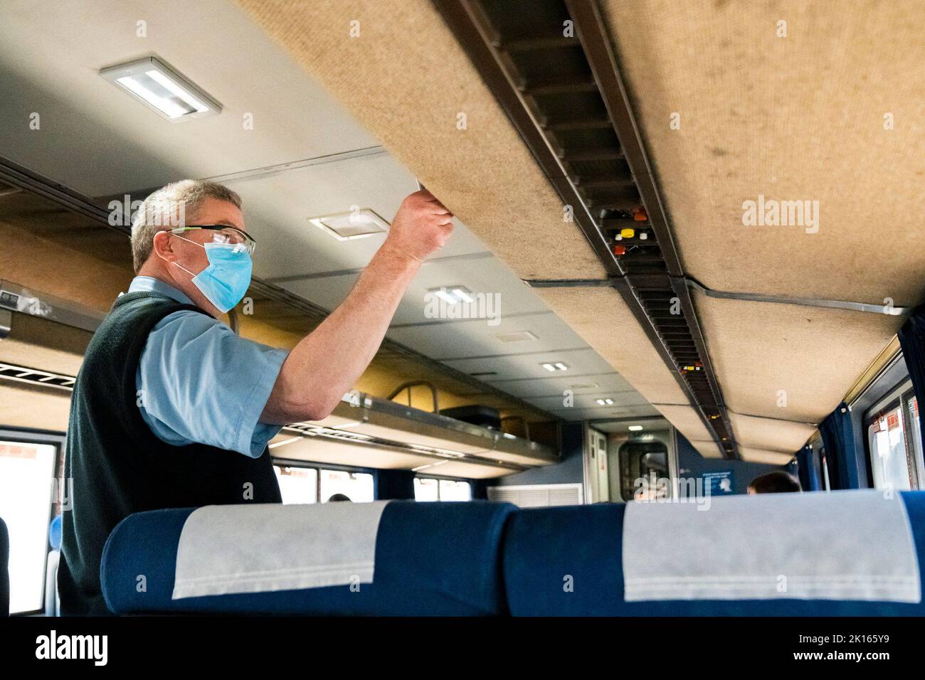 An Amtrak conductor checks tickets in Chicago, Illinois March 20, 2021 ...
